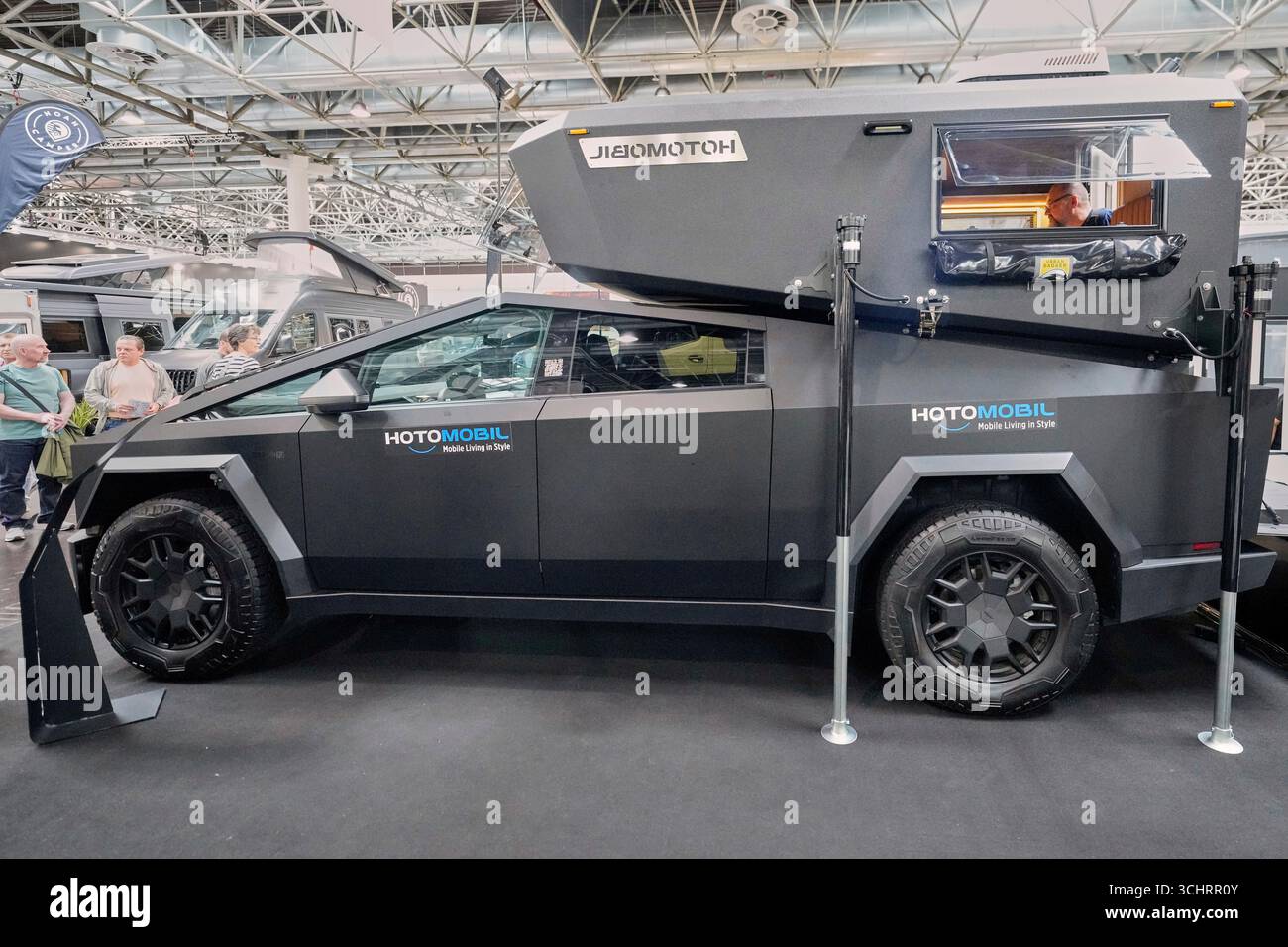 A Tesla Cybertruck is pictured with a detachable truck camper with ...