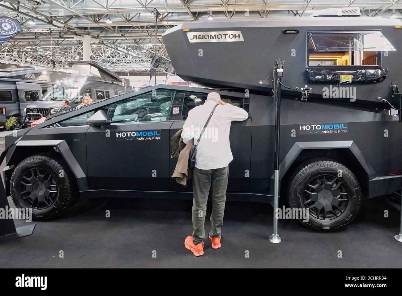 A Tesla Cybertruck is pictured with a detachable truck camper with ...