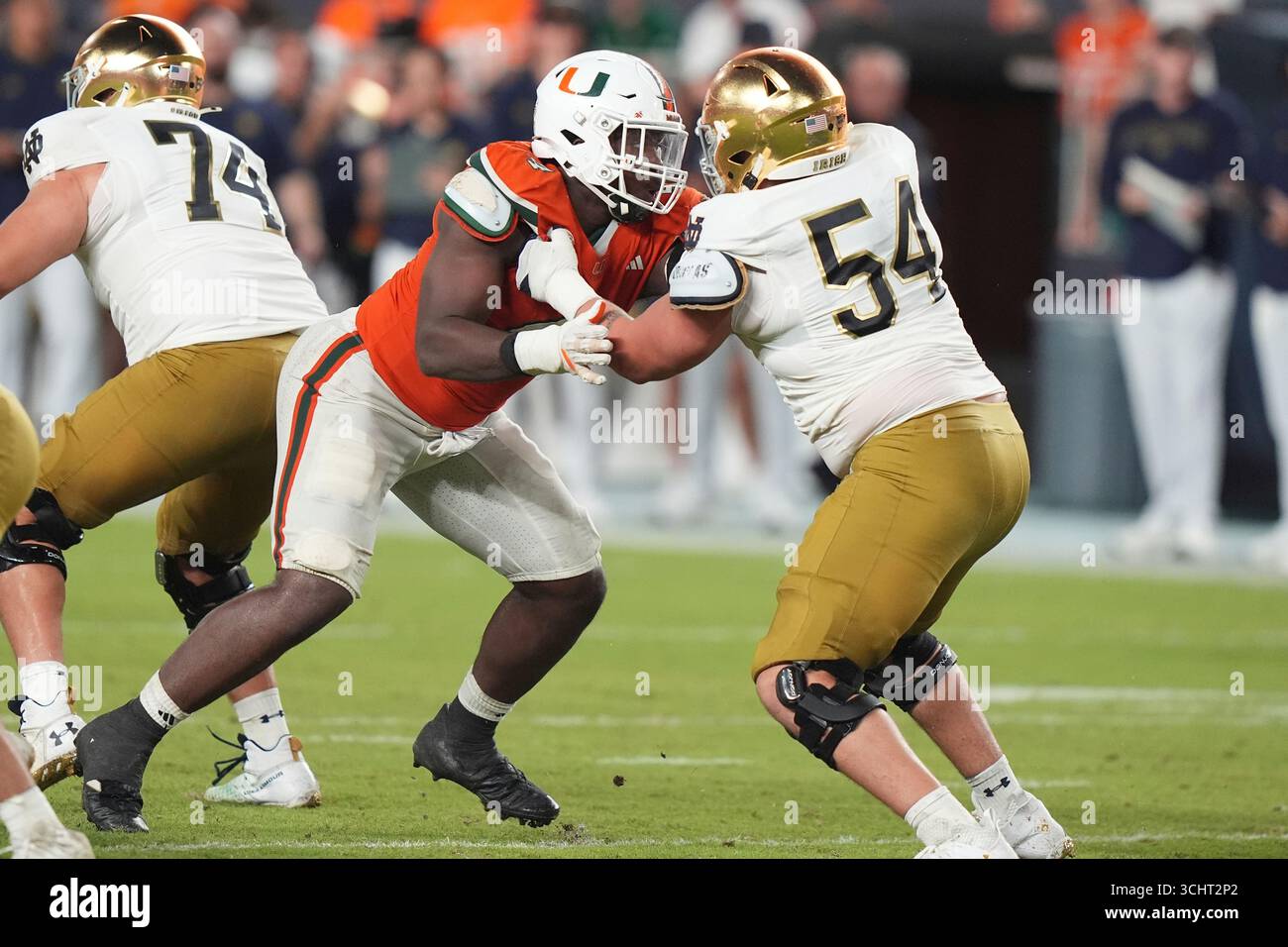 Miami defensive lineman Rueben Bain Jr., left, defends Notre Dame ...