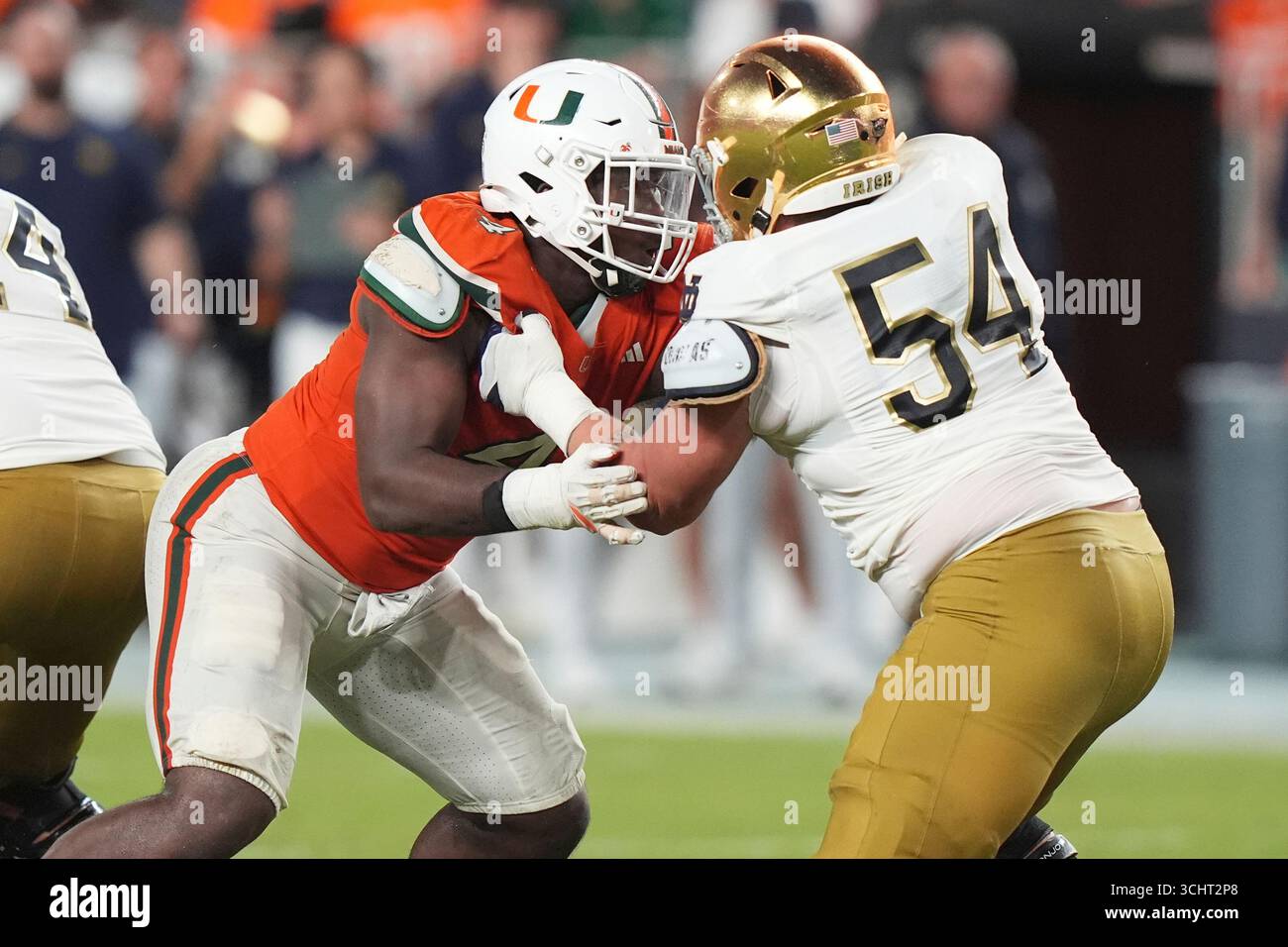 Miami defensive lineman Rueben Bain Jr., left, defends Notre Dame ...
