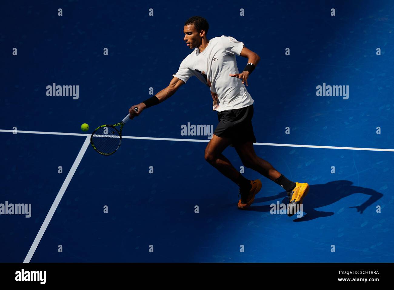 Felix Auger-Aliassime, of Canada, returns a shot to Alex de Minaur, of Australia, during the ...