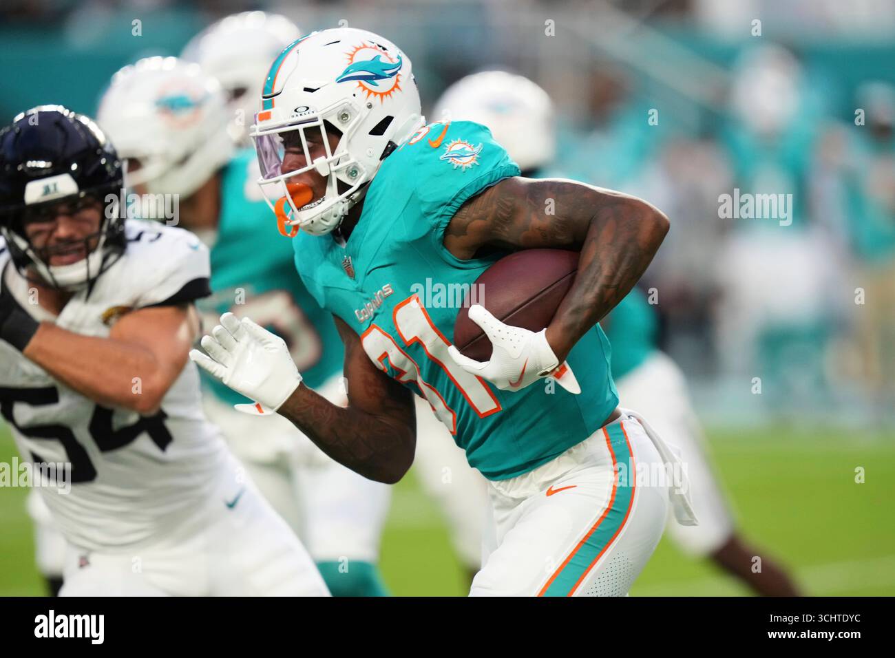 Miami Dolphins running back Ollie Gordon II (31) runs during the first half of a preseason NFL ...