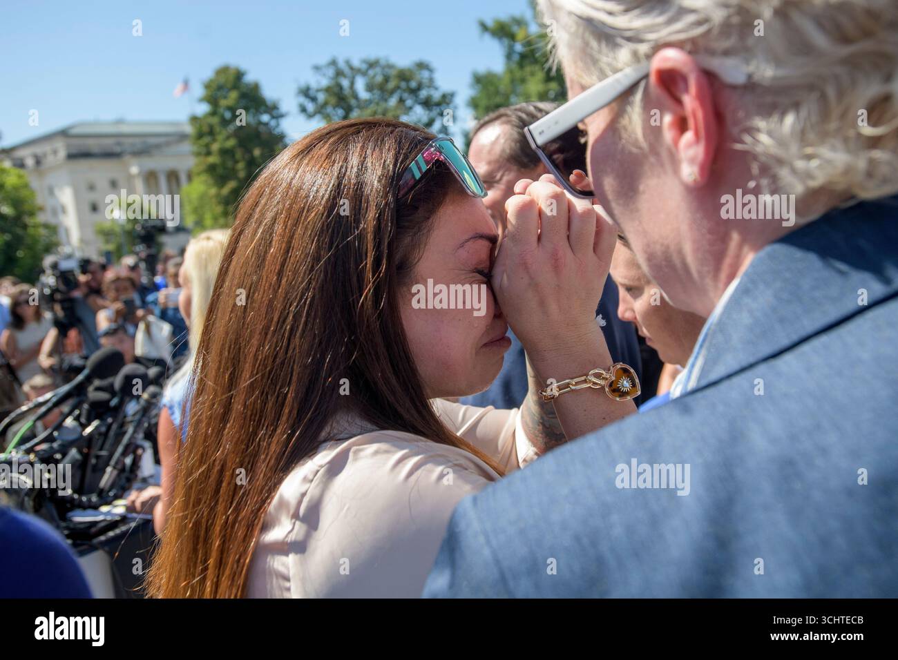 Haley Robson wipes tears from her eyes after speaking during a news ...