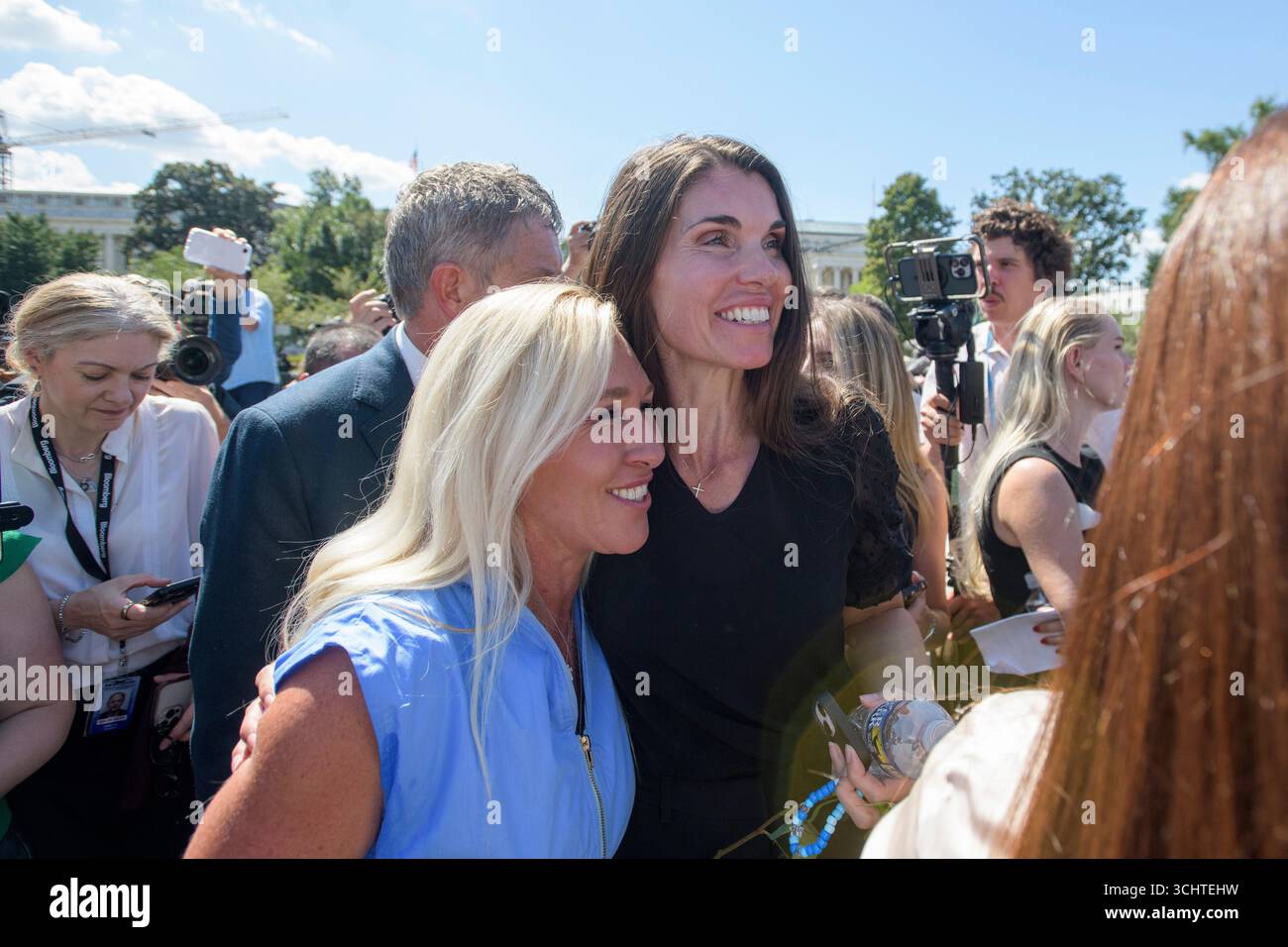 Rep. Marjorie Taylor-Greene, R-Ga., left, talks with Teresa J. Helm ...