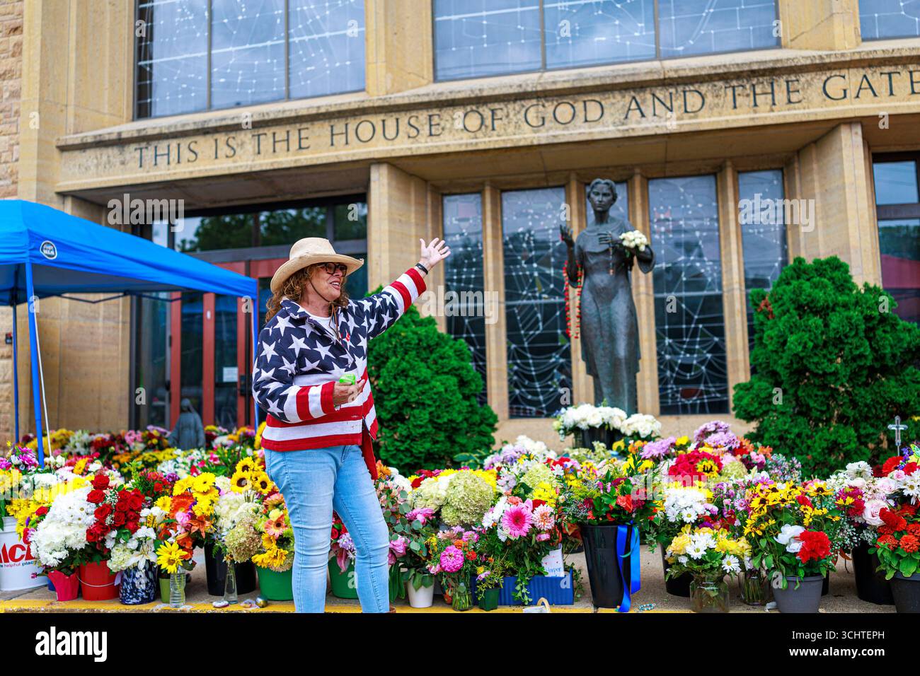 Robin Puttin prays at a memorial of flowers and tributes outside of ...