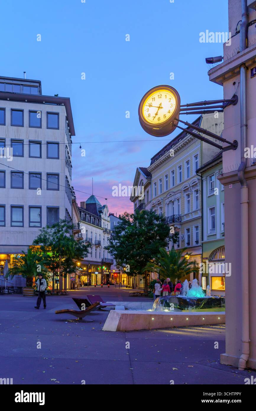 Baden-Baden, Germany - October 13, 2024: Sunset street view, with various buildings, locals and ...