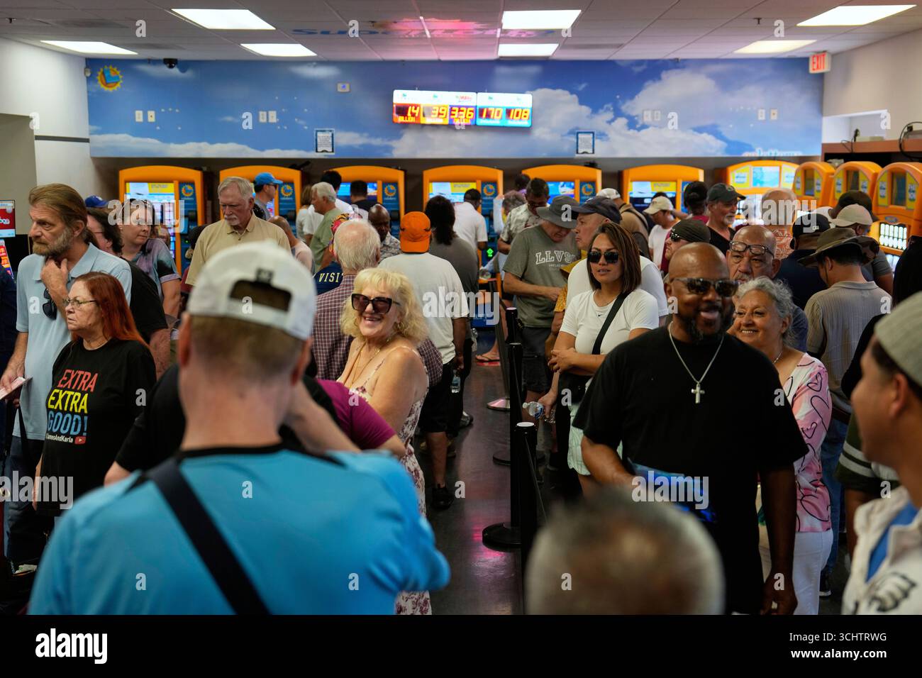 People wait in line to buy lottery tickets at the Lotto Store just ...