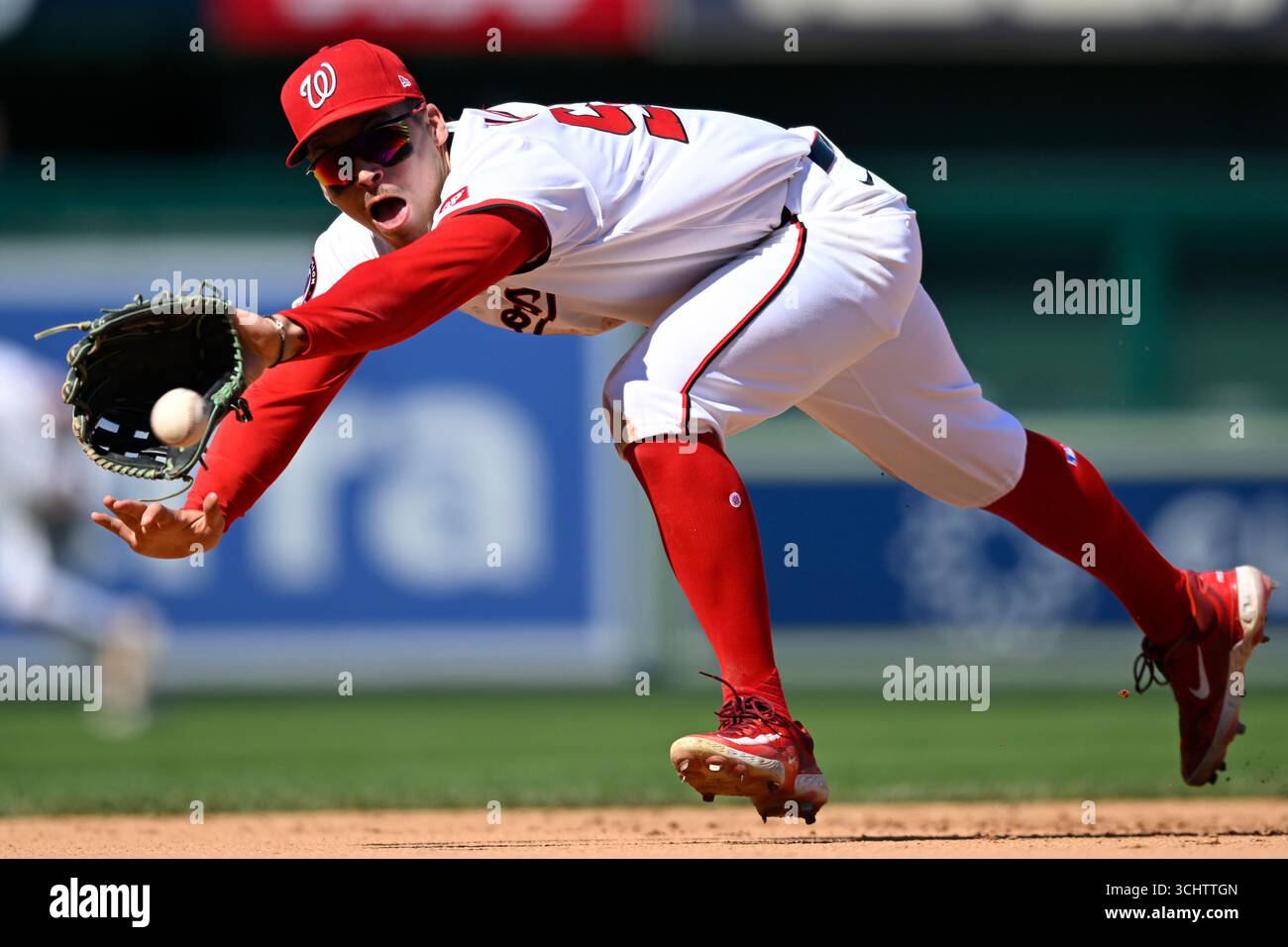 Washington Nationals third baseman Brady House can't get the glove on a ...