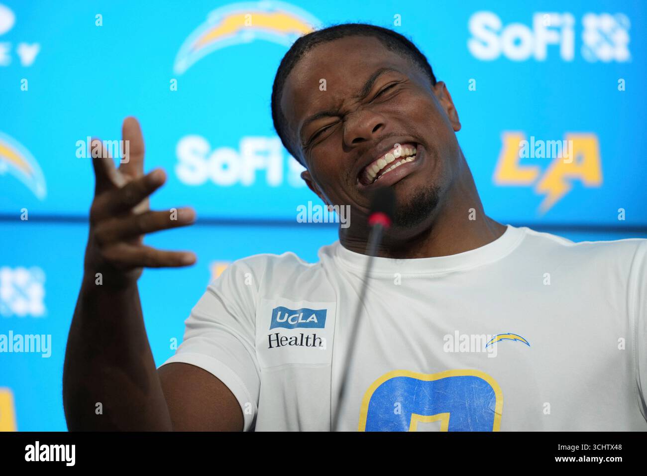 Los Angeles Chargers linebacker Daiyan Henley jokes with the press ...
