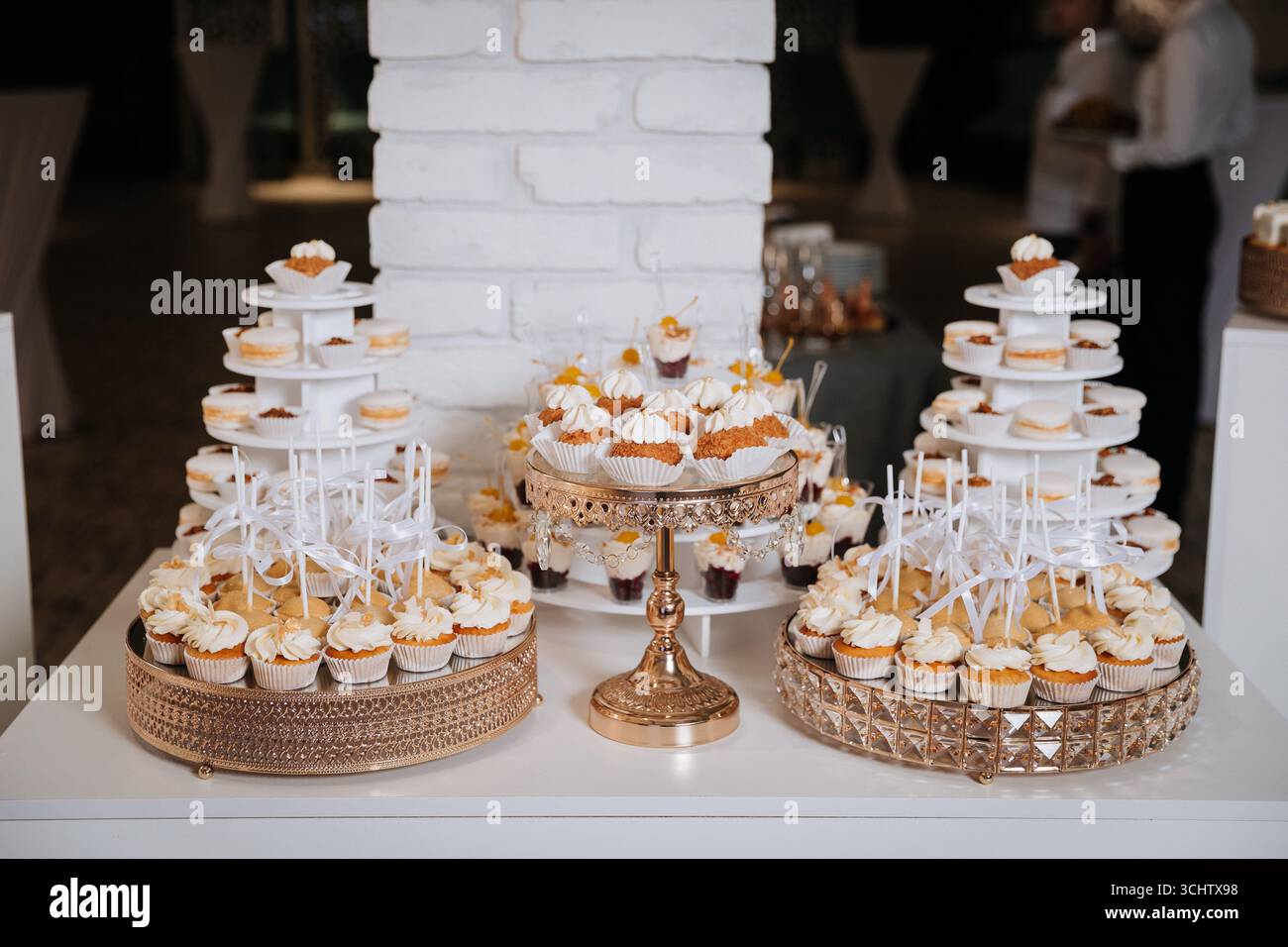 Elegant dessert table with cupcakes and sweets at a luxury celebration ...