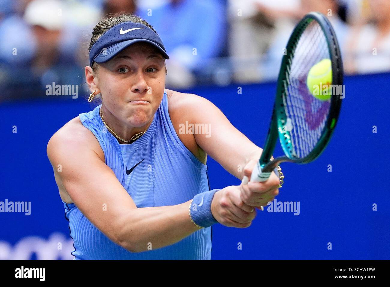 Amanda Anisimova, of the United States, returns a shot to Iga Swiatek ...