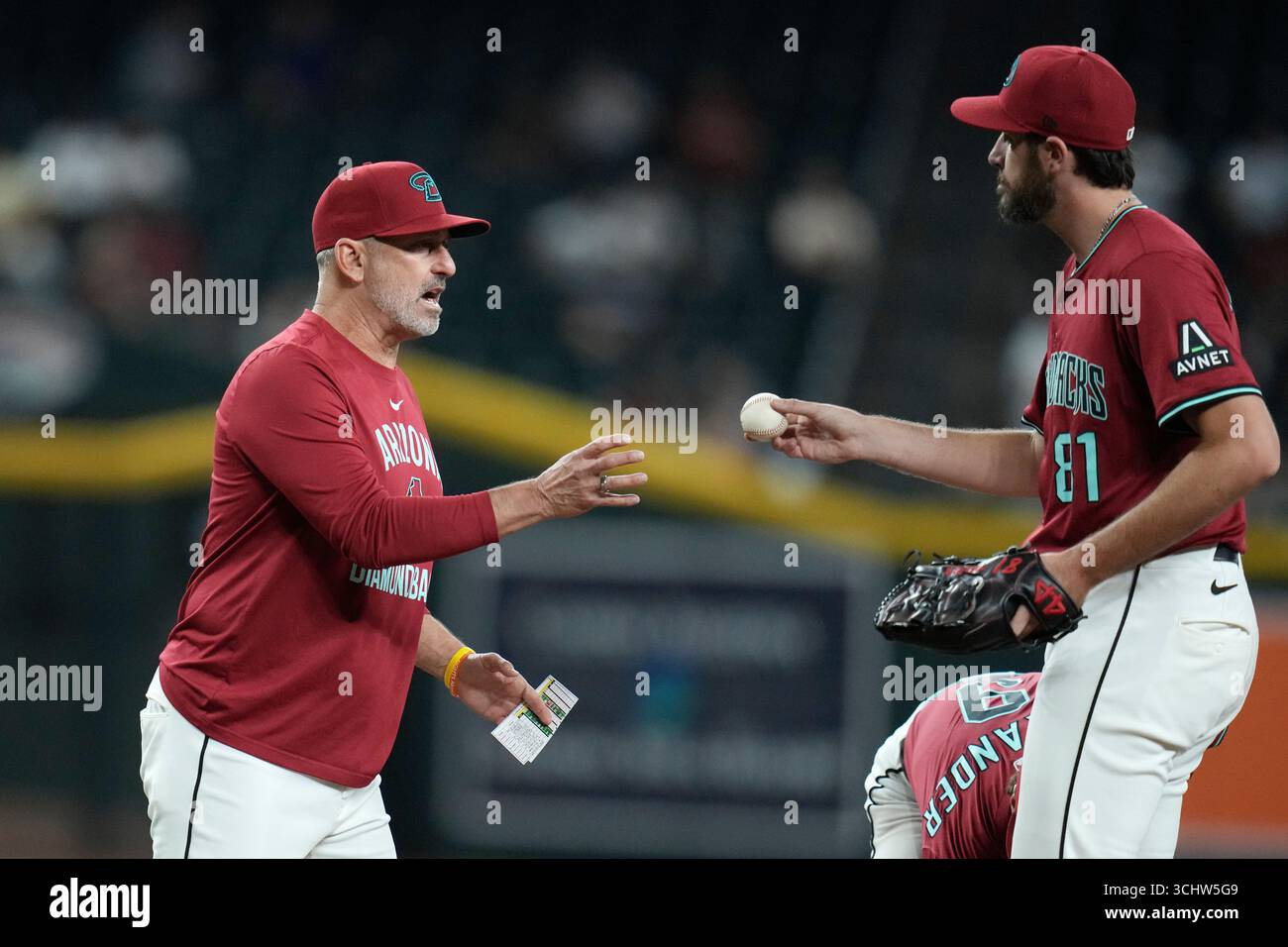 Arizona Diamondbacks manager Torey Lovullo, left, takes the ball from ...