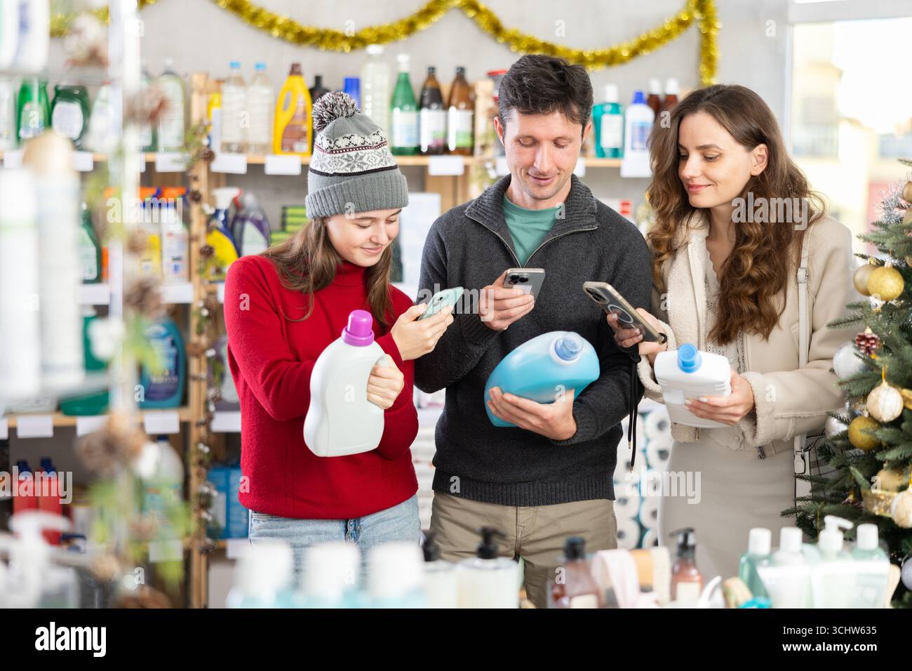 Couple man and woman with daughter scanning qr code for detergent Stock ...