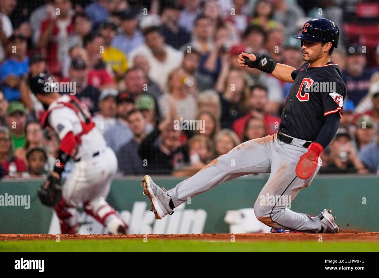 Cleveland Guardians' Steven Kwan, right, scores on a wild pitch as ...
