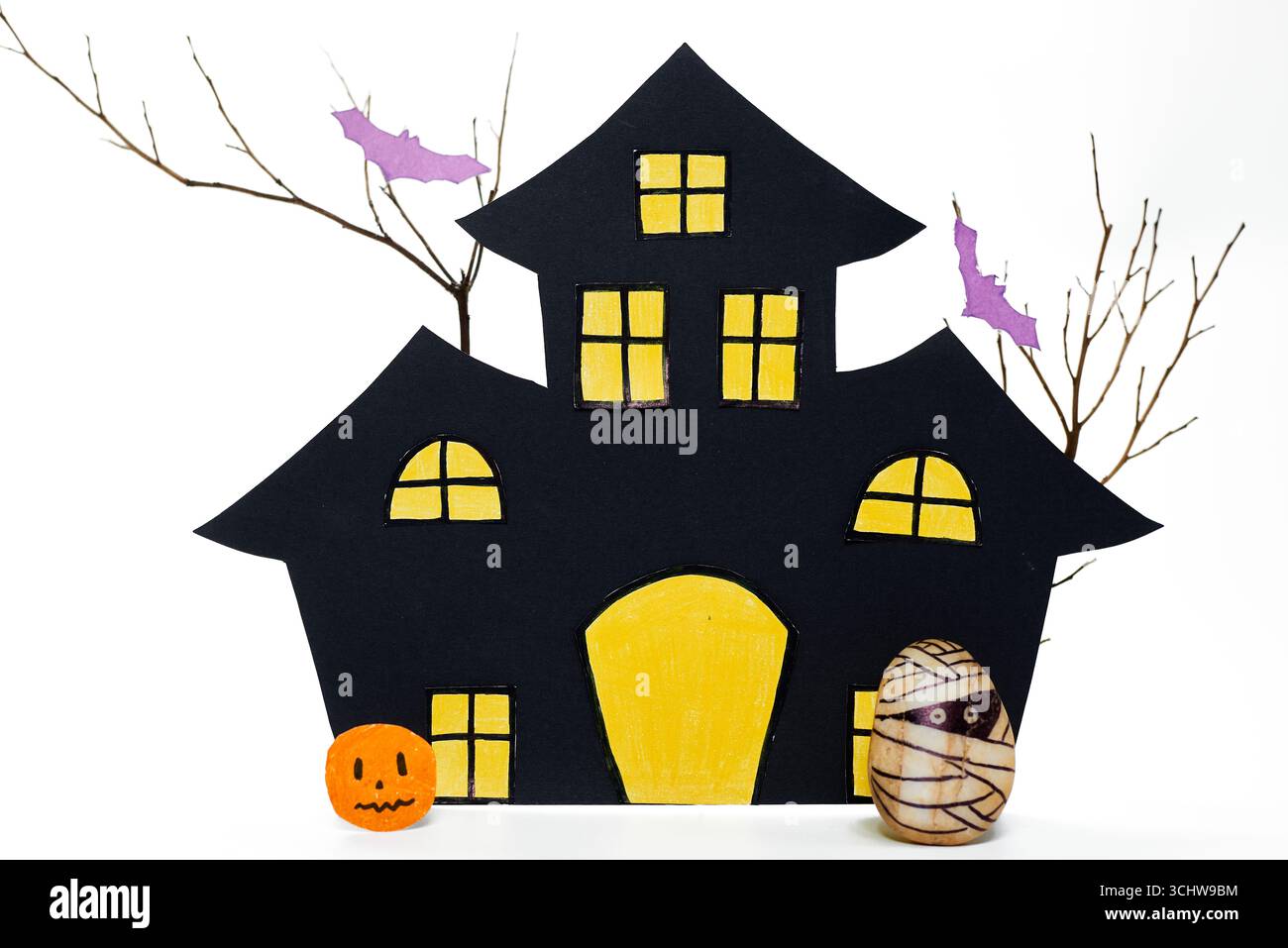Handmade Halloween haunted house with glowing windows, decorated with ...