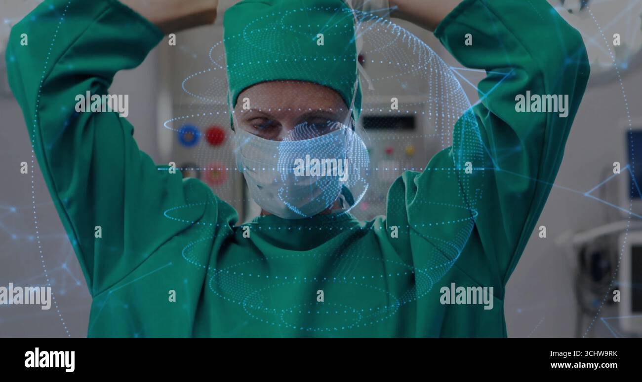 Surgeon in green scrubs and mask securing cap straps in operating room ...