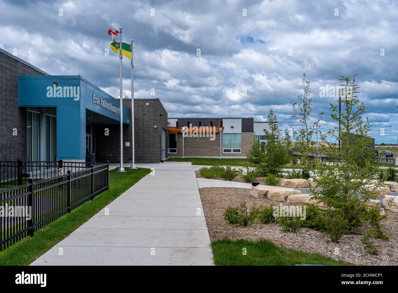 Ground-level photo capturing the modern front entrance of École ...