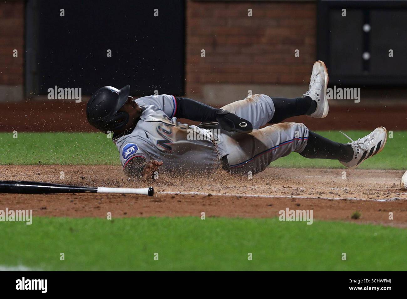 Miami Marlins' Xavier Edwards slides into home plate to score on a hit ...