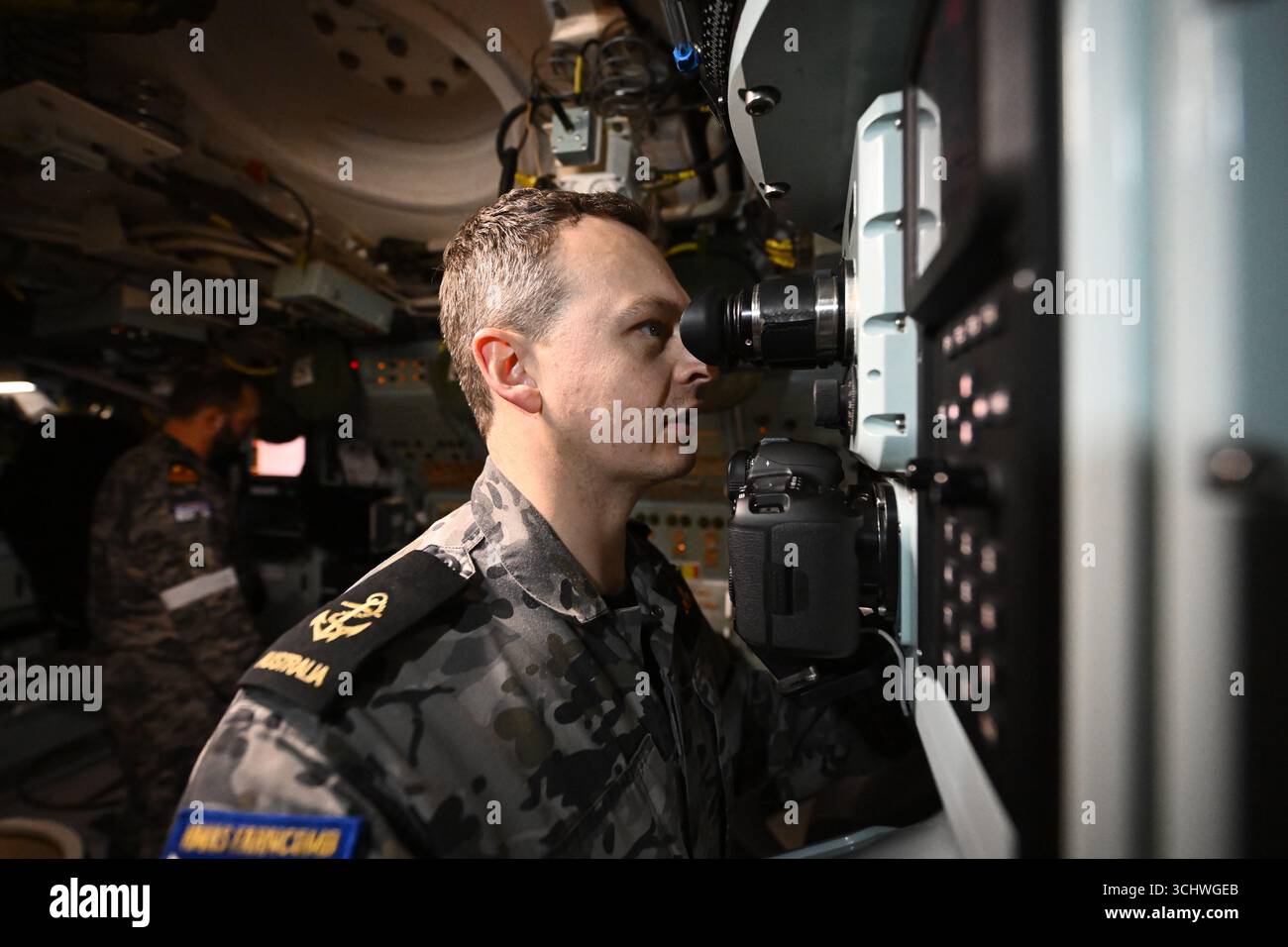 Leading Seaman Gerard Acoustic Warfare Analyst looks through a ...