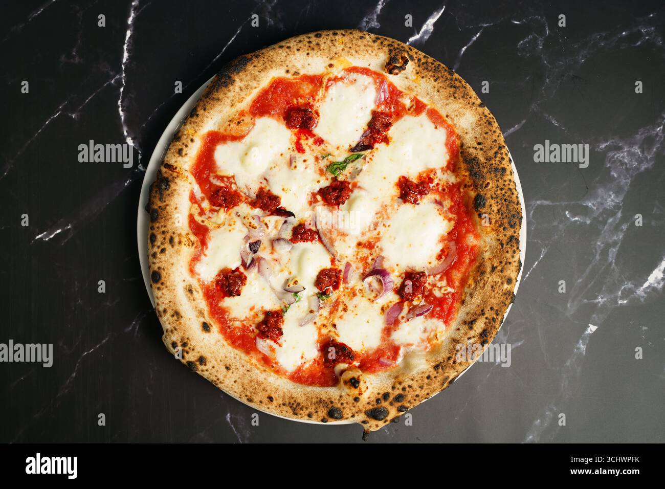 Overhead view of a freshly baked Neapolitan-style pizza topped with ...