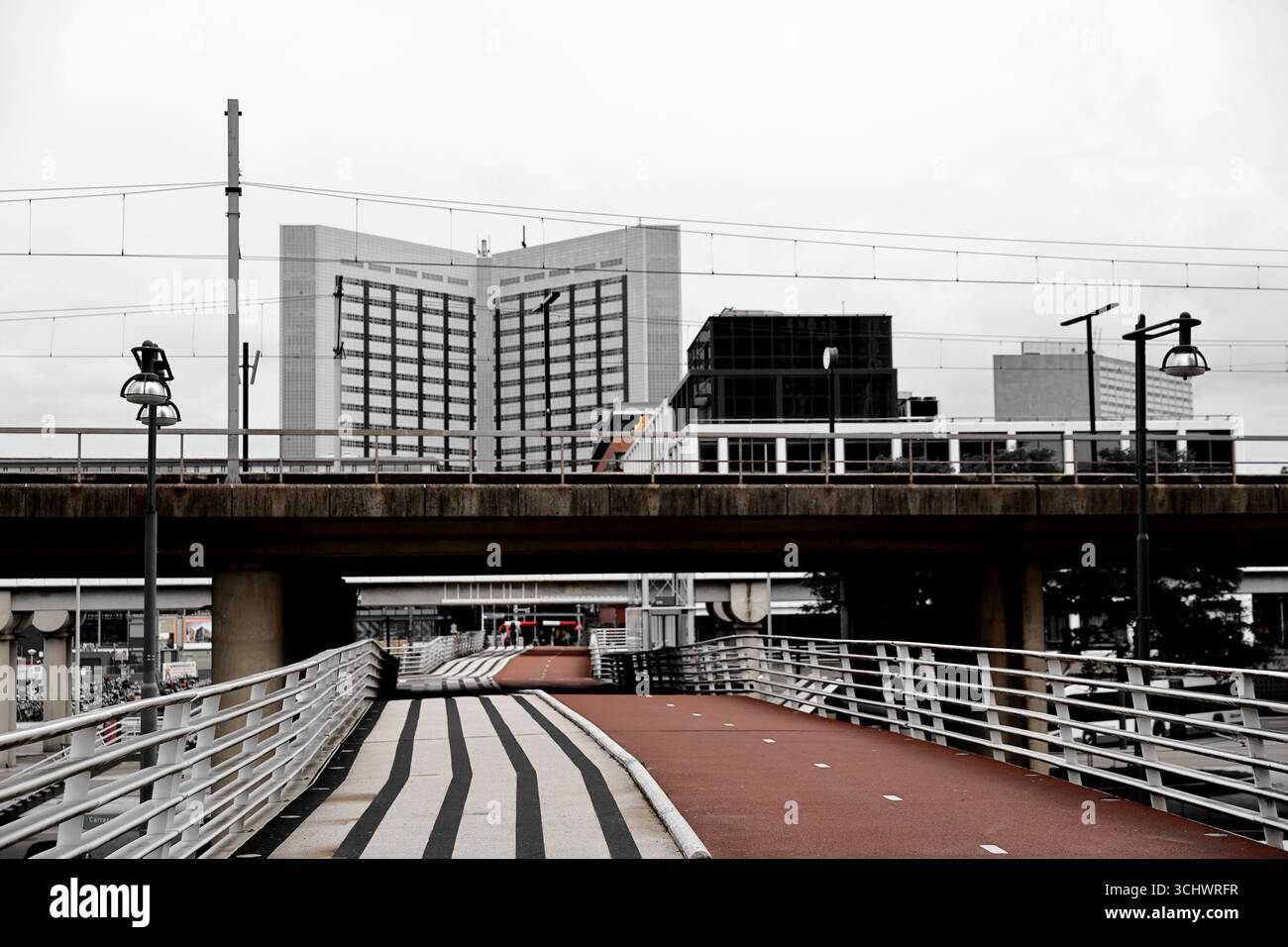 Curved pedestrian and cycle bridge beneath rail tracks at Station ...