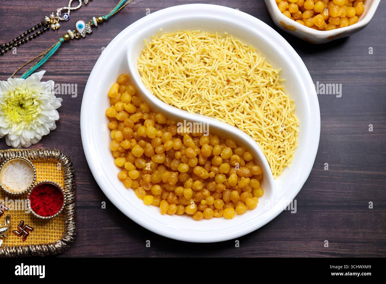 A close up of traditional Indian snacks. crispy savory sev and sweet ...