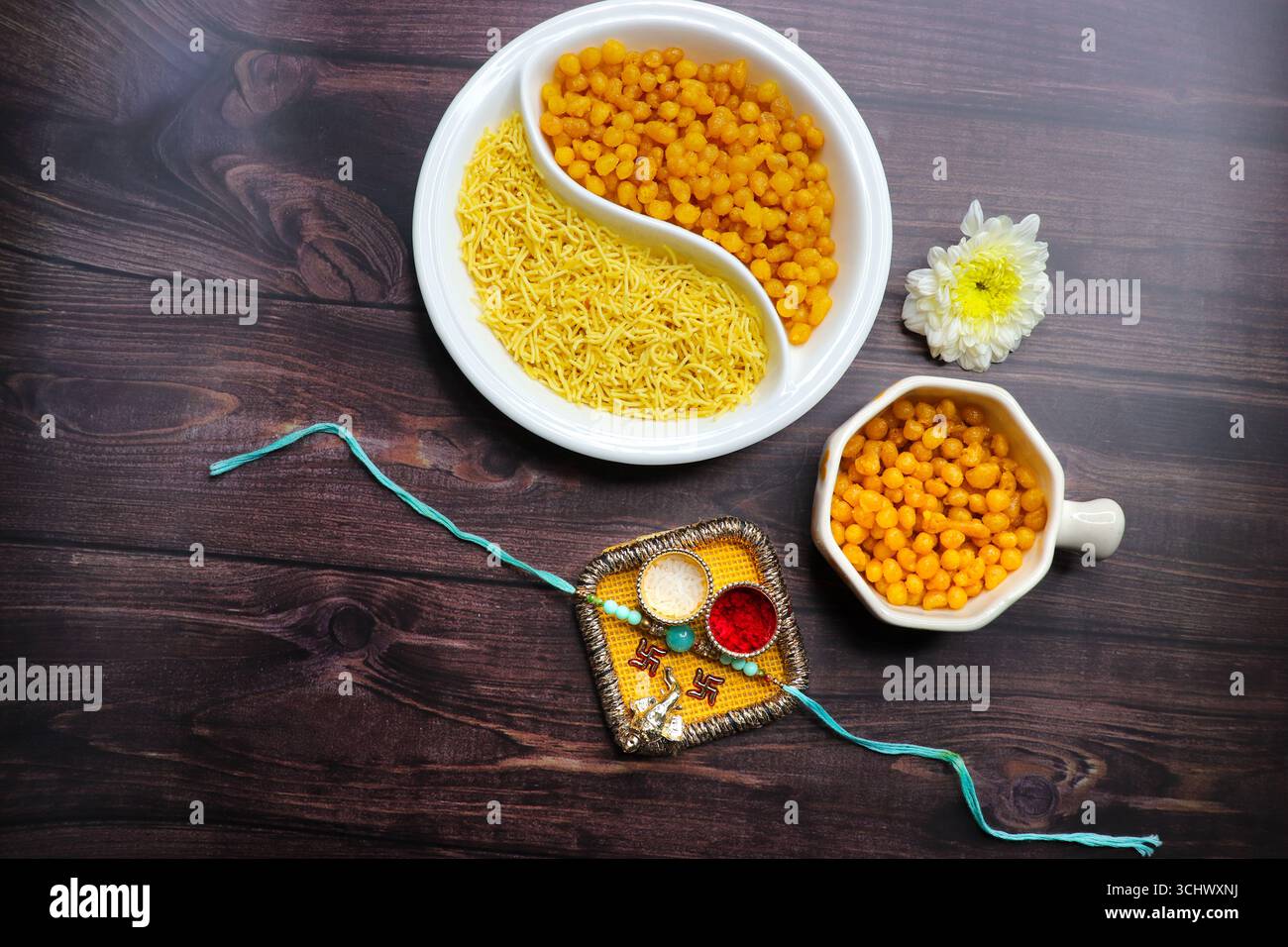 A close up of traditional Indian snacks. crispy savory sev and sweet ...