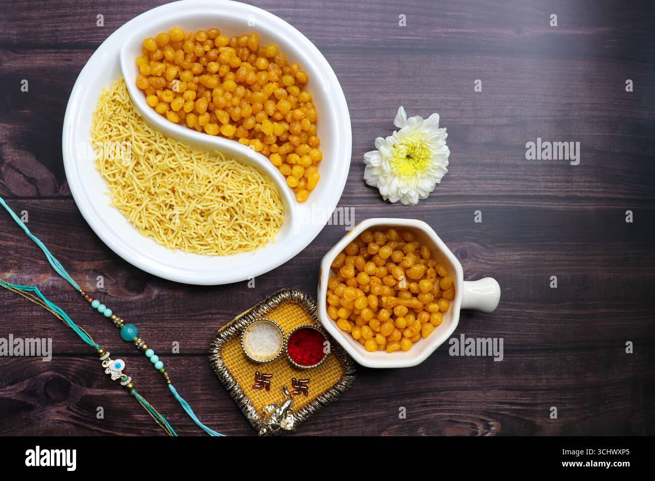 A close up of traditional Indian snacks. crispy savory sev and sweet ...