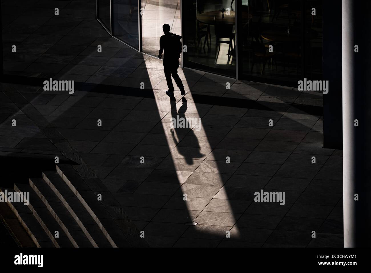 04 September 2025, Berlin: A passer-by walks along the Spree next to ...