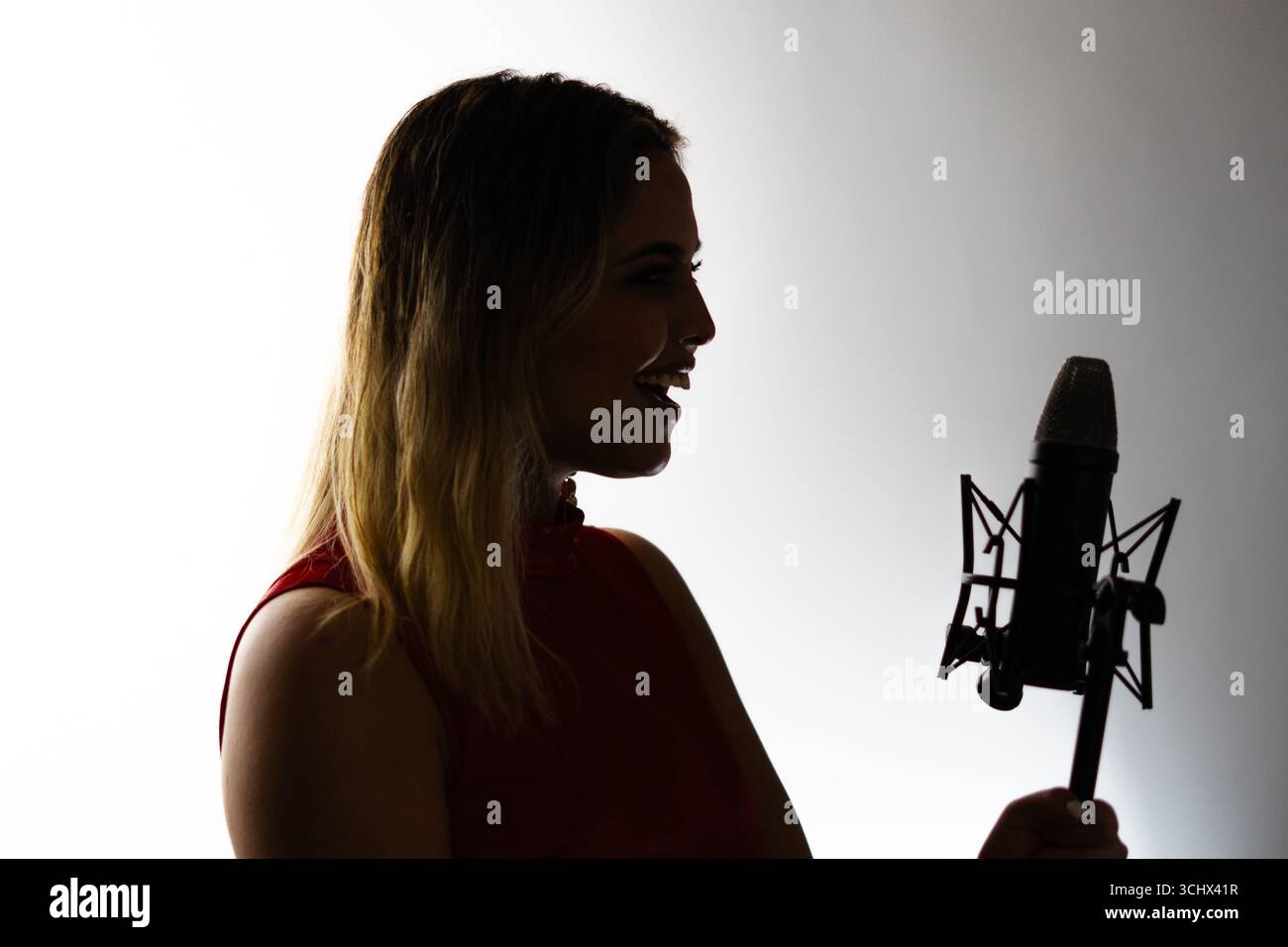 Female vocalist singing passionately into a microphone, creating a ...