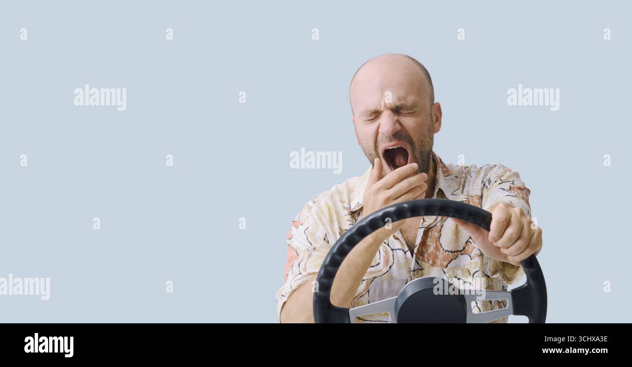 Irresponsible driver falling asleep while driving, he is holding the ...
