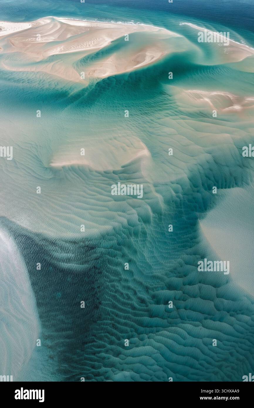 Aerial view of shifting sands meet the turquoise sea, creating ...