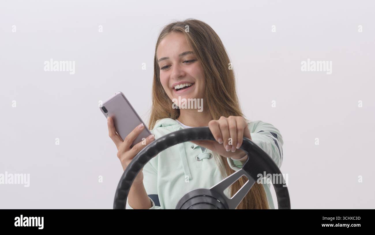 Distracted careless young woman texting while driving a car, isolated ...