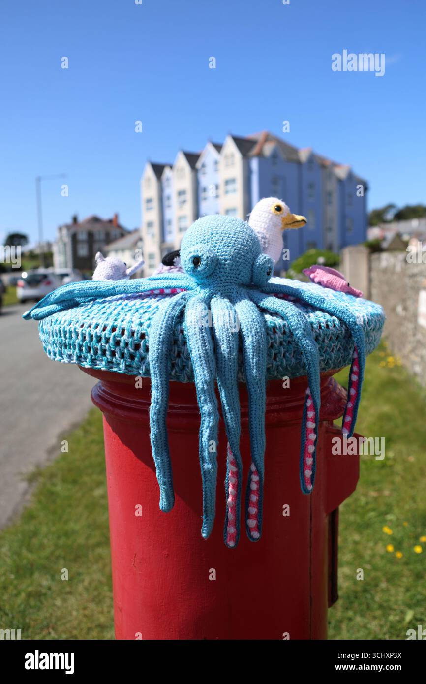 Royal Mail postbox with knitted topper of beach scene with seagull and ...