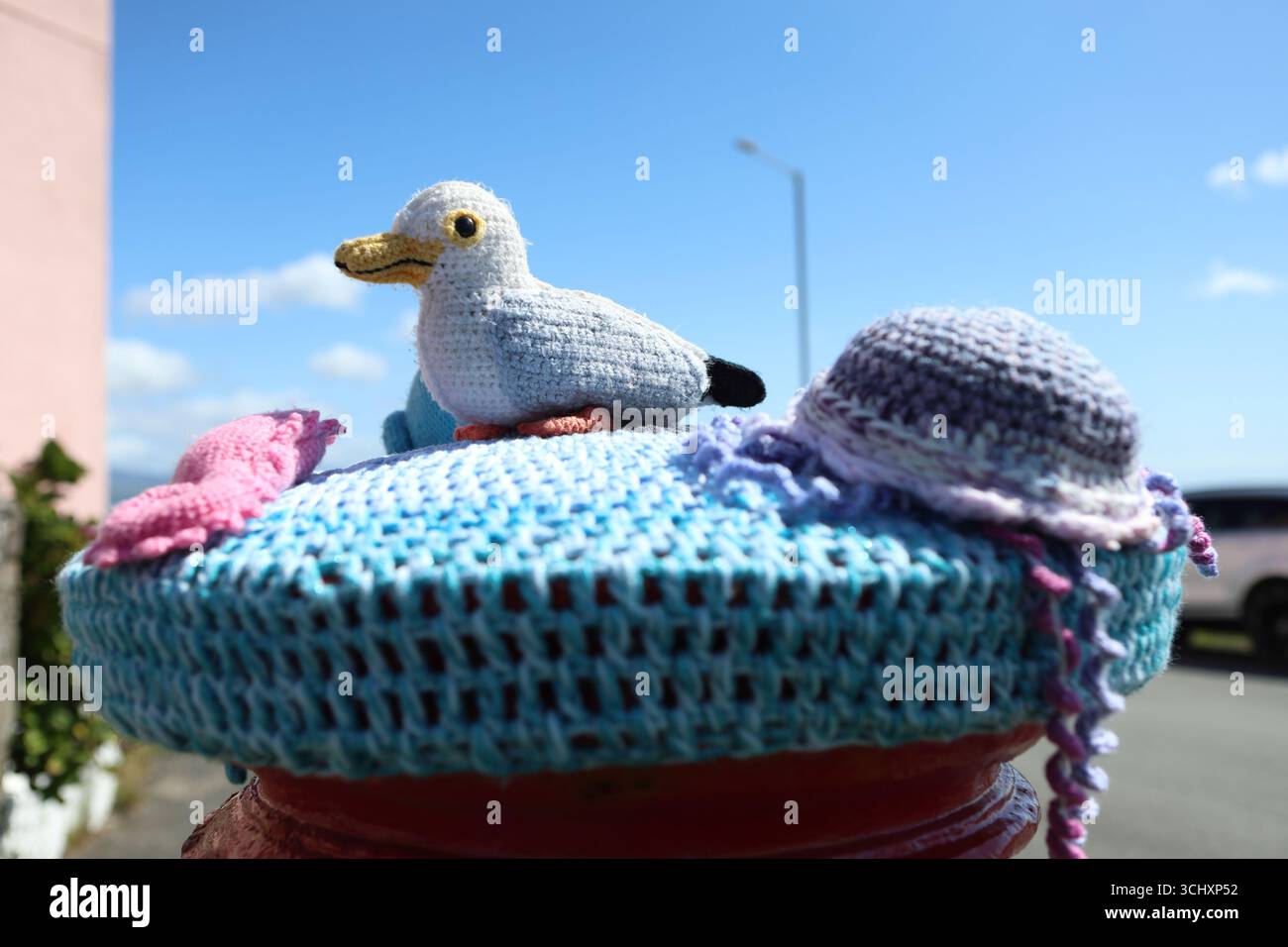 Royal Mail postbox with knitted topper of beach scene with seagull ...