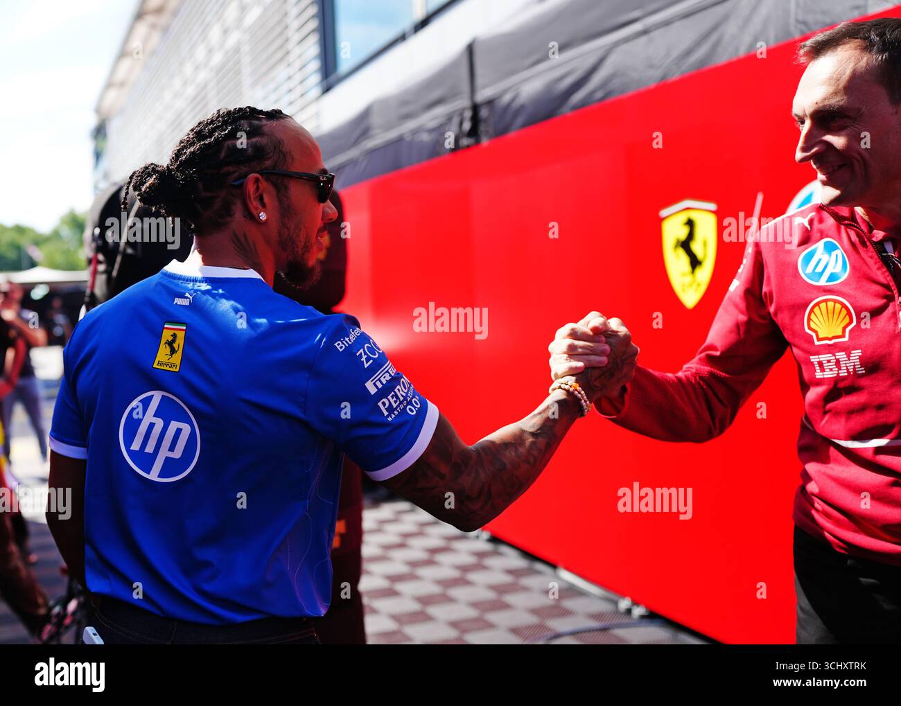 Ferrari's Lewis Hamilton greets engineer Riccardo Adami at Monza, ahead ...