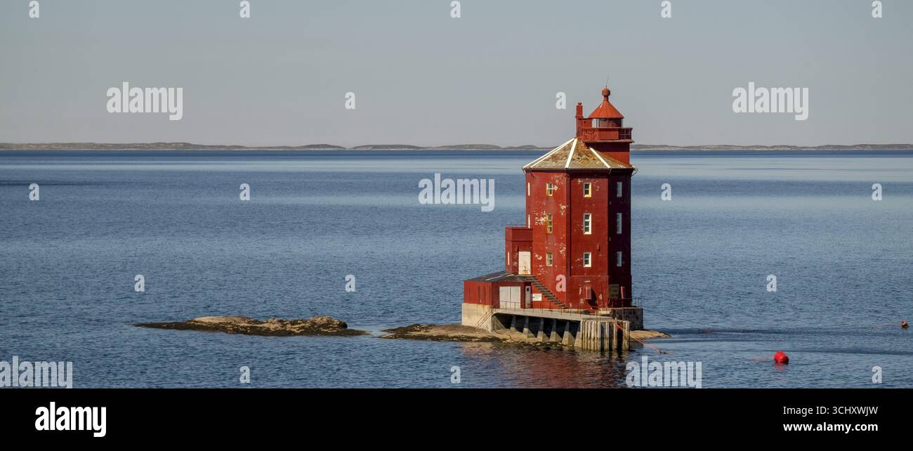Kjeungskjaer Fyr, red lighthouse, off the Norwegian coast on a small ...