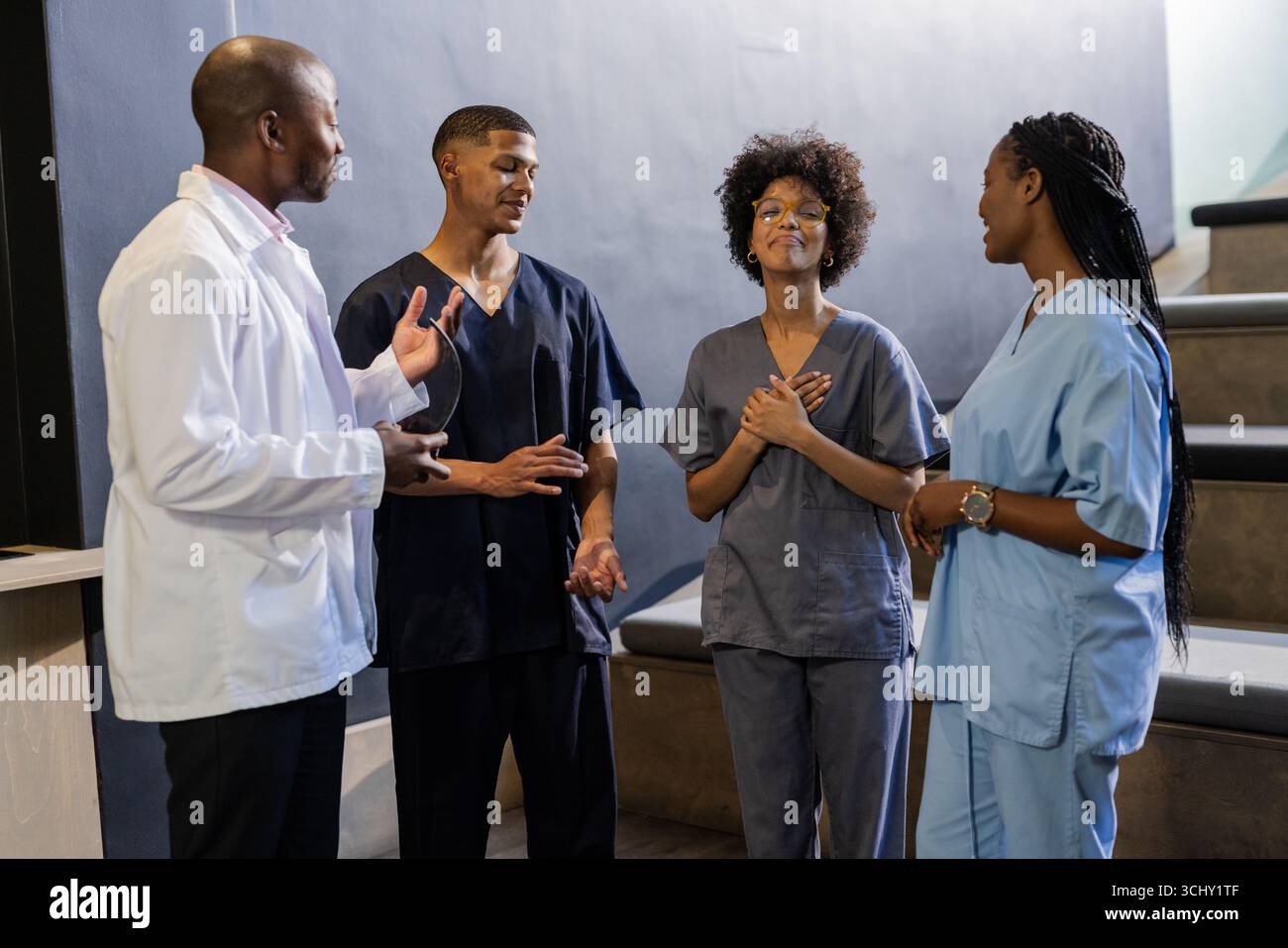 Collaborating medical staff wearing hi-res stock photography and images ...