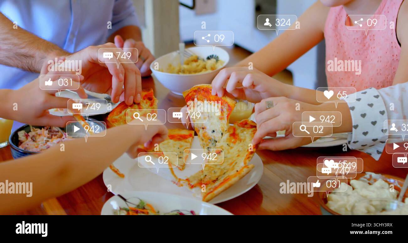 Reaching family members grabbing cheese pizza on dining table at home ...