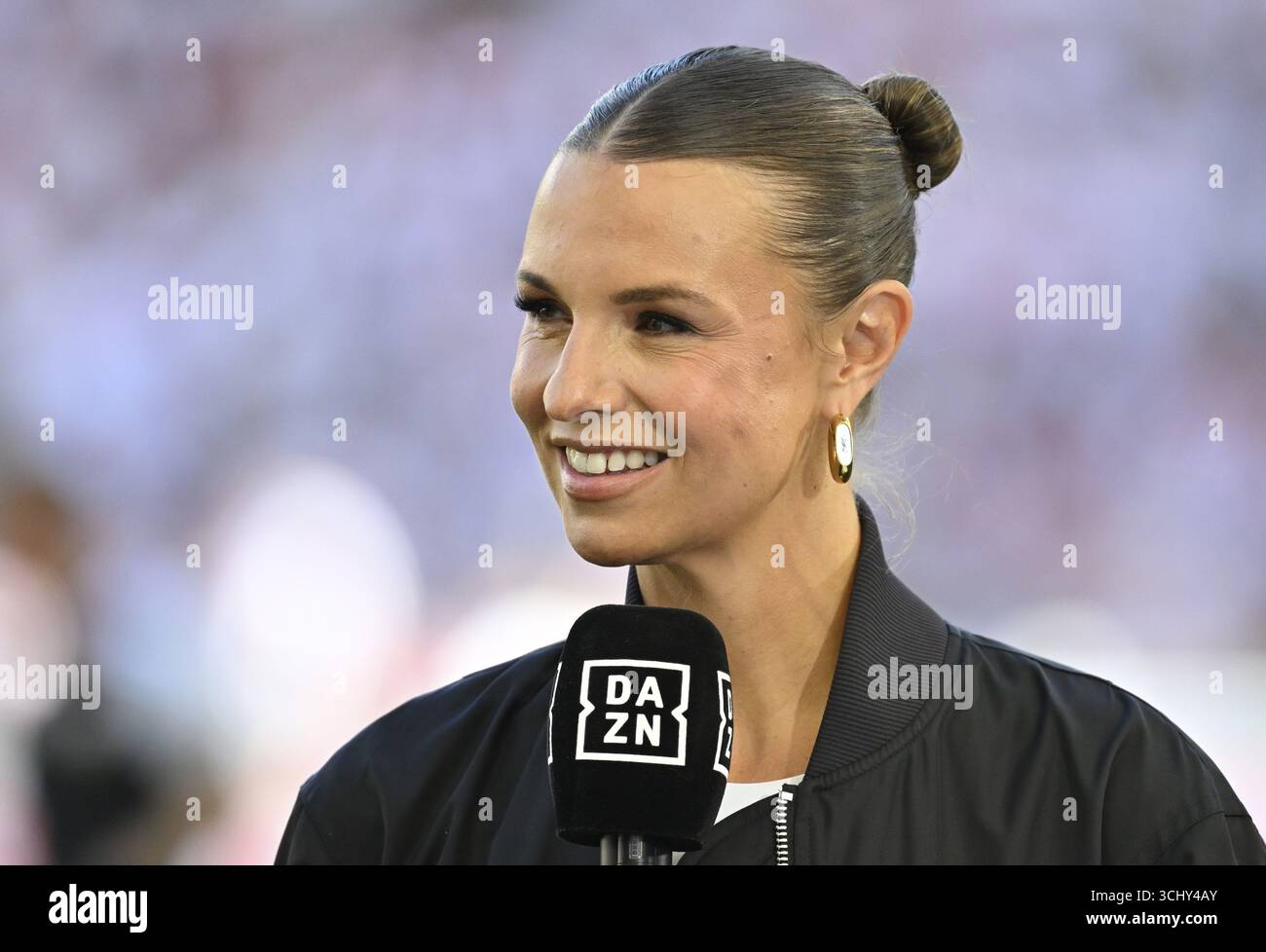 DAZN presenter Laura Wontorra, smiling in interview microphone ...