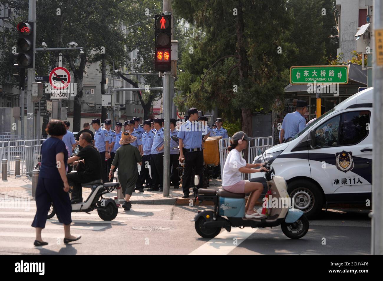 Chinese police officers gather at a traffic junction a block away from ...