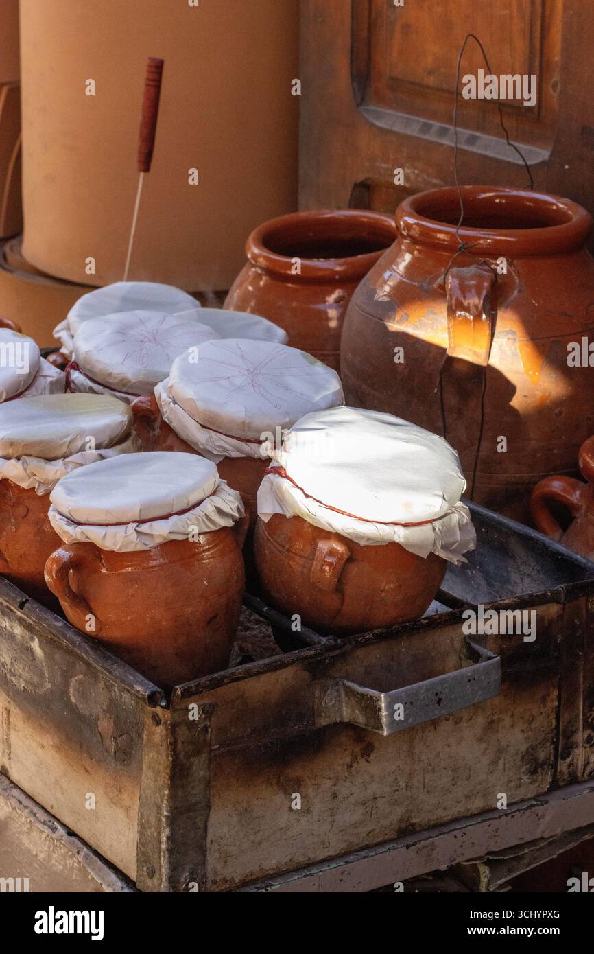 morning light on tagine earthenware clay pots covered in cloth on a ...