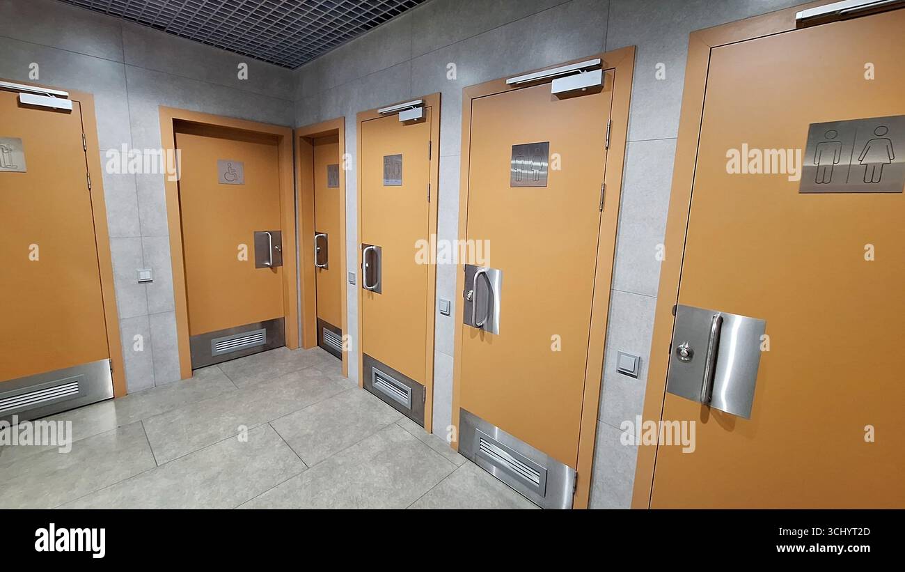 Public restroom interiors with multiple stall doors in modern design ...