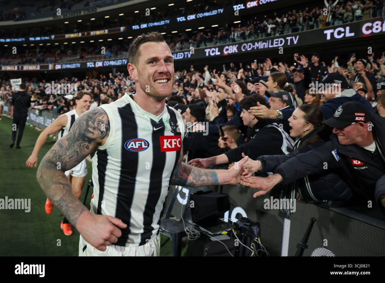 Tim Membrey of the Magpies and fans celebrate victory during the AFL ...