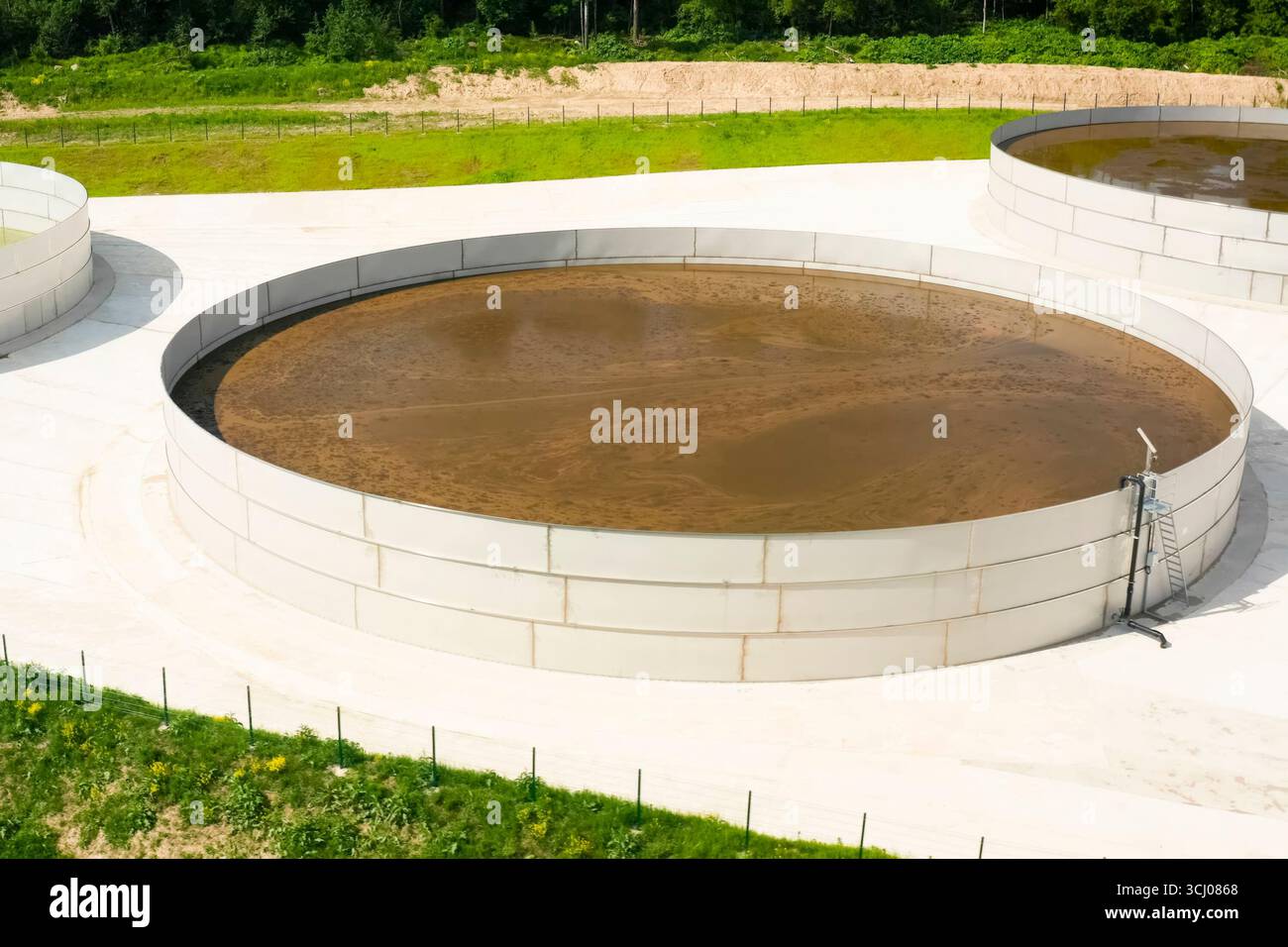 Manure treatment tanks at biogas production factory Stock Photo - Alamy