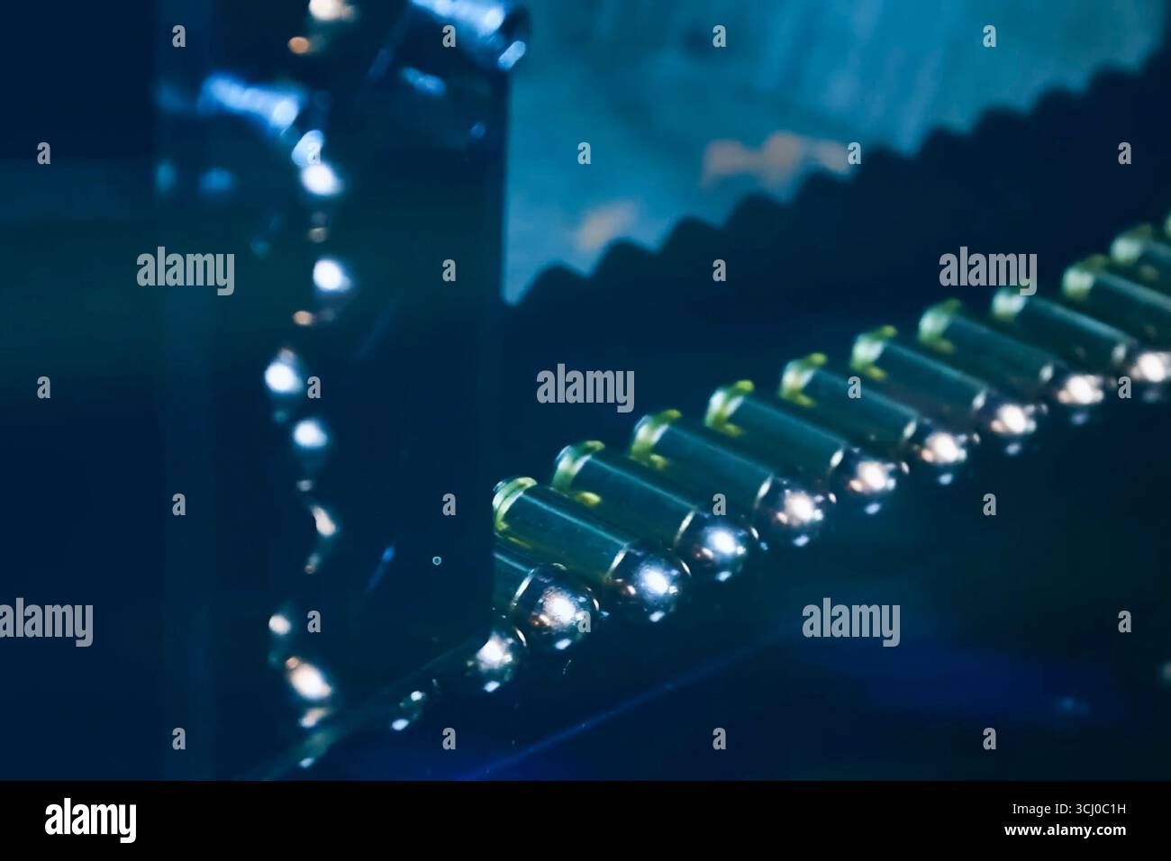 Ready-made bullets for a pistol on a conveyor in a row Stock Photo - Alamy
