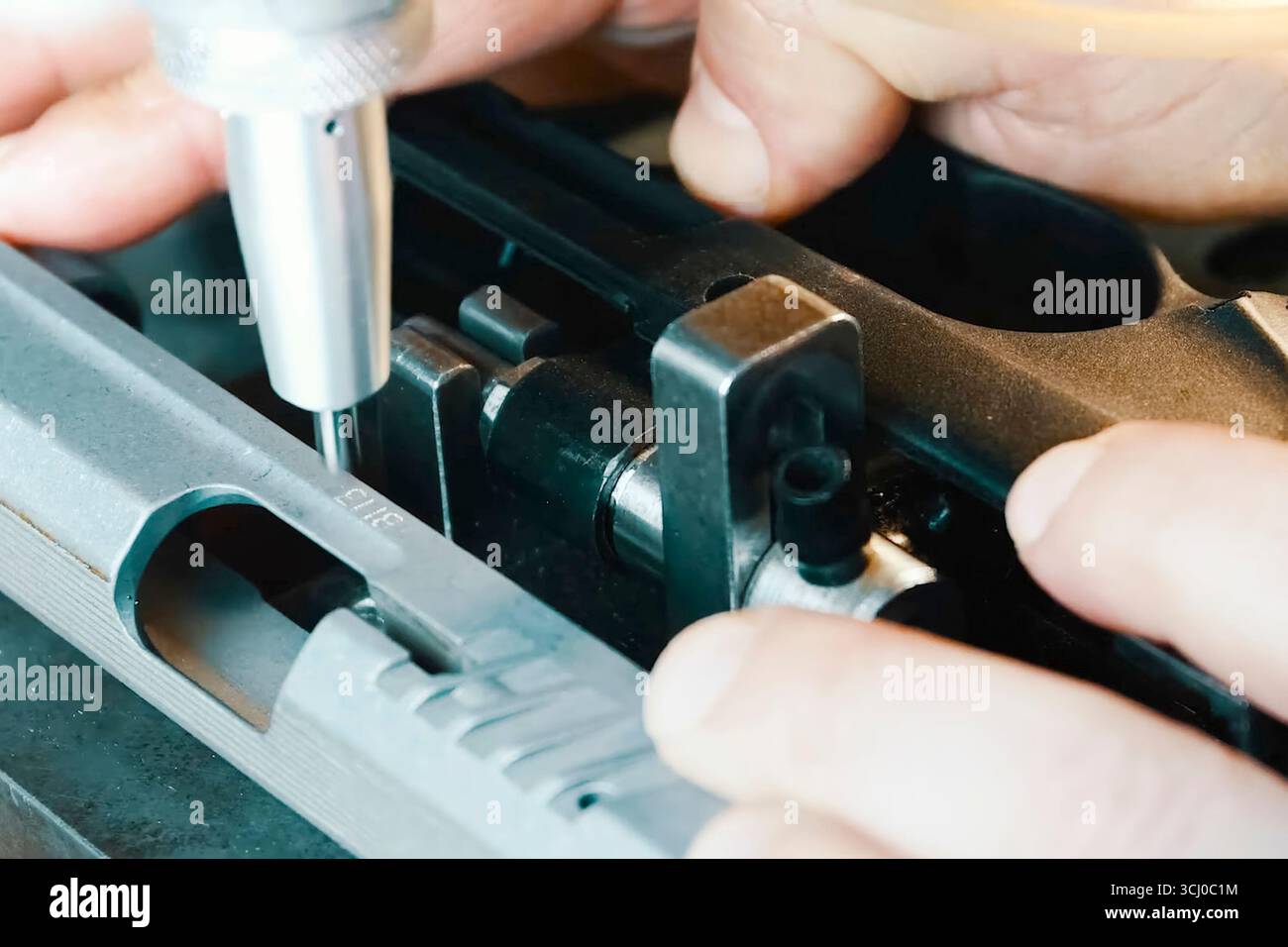 Engraving the serial number on a pistol using a special numbering ...