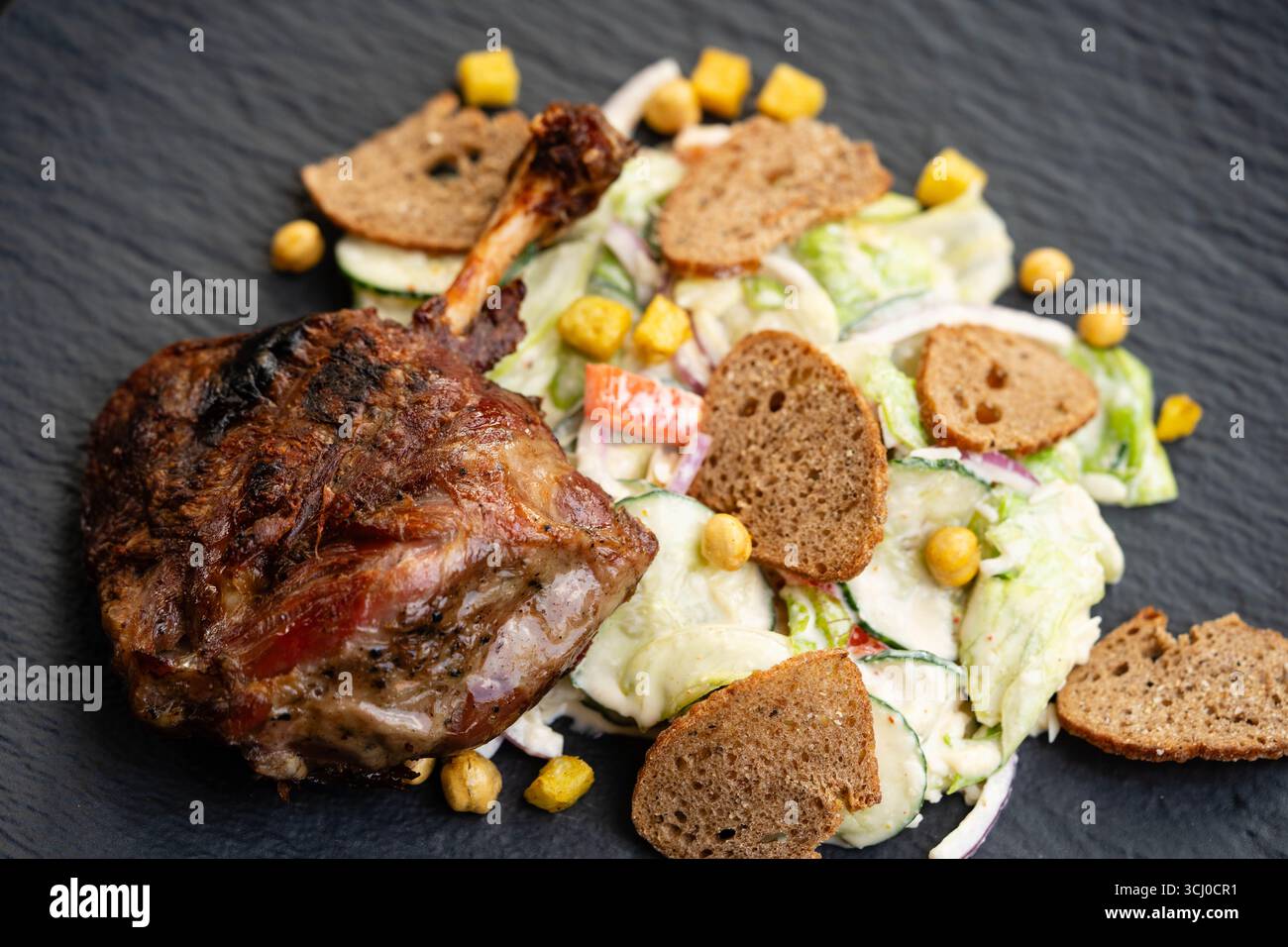 grilled pig wings - sliced open pork knuckle of a young pig with ...