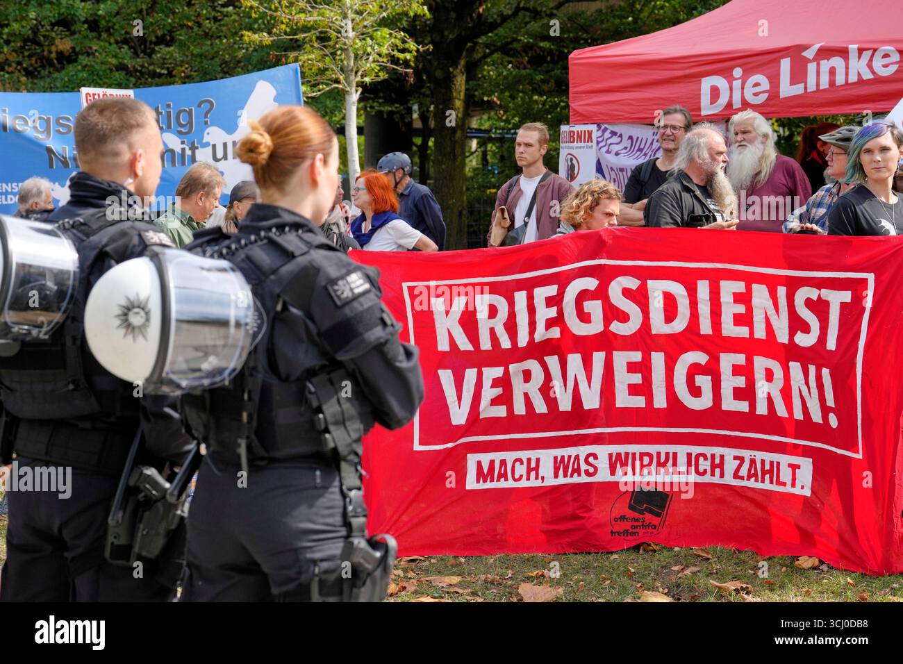 Protestors show a banner reading "Refuse military service" when new ...