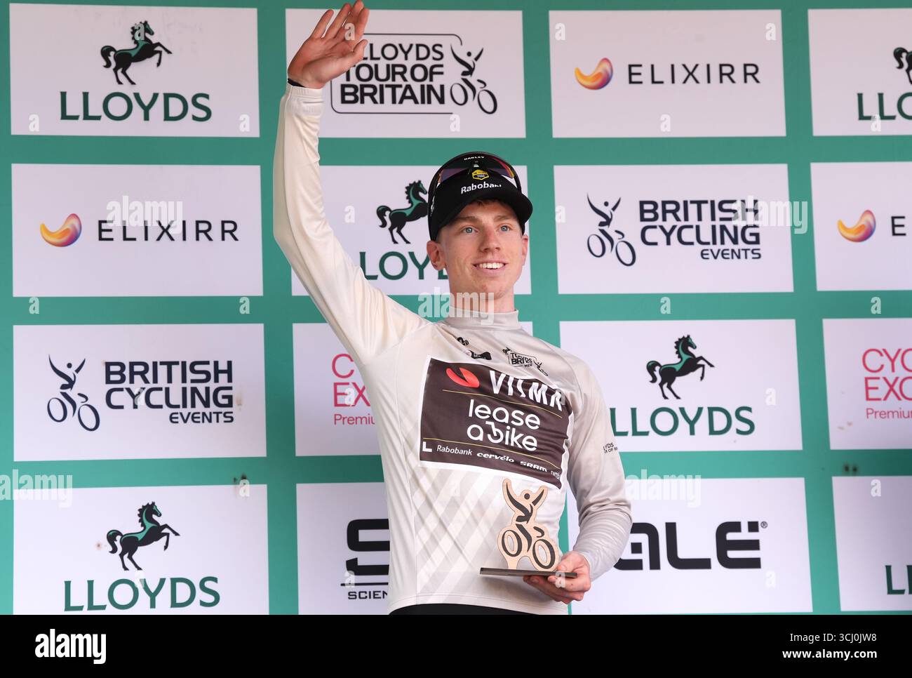 Matthew Brennan of Team Visma | Lease a Bike is presented with a trophy after being crowned best ...